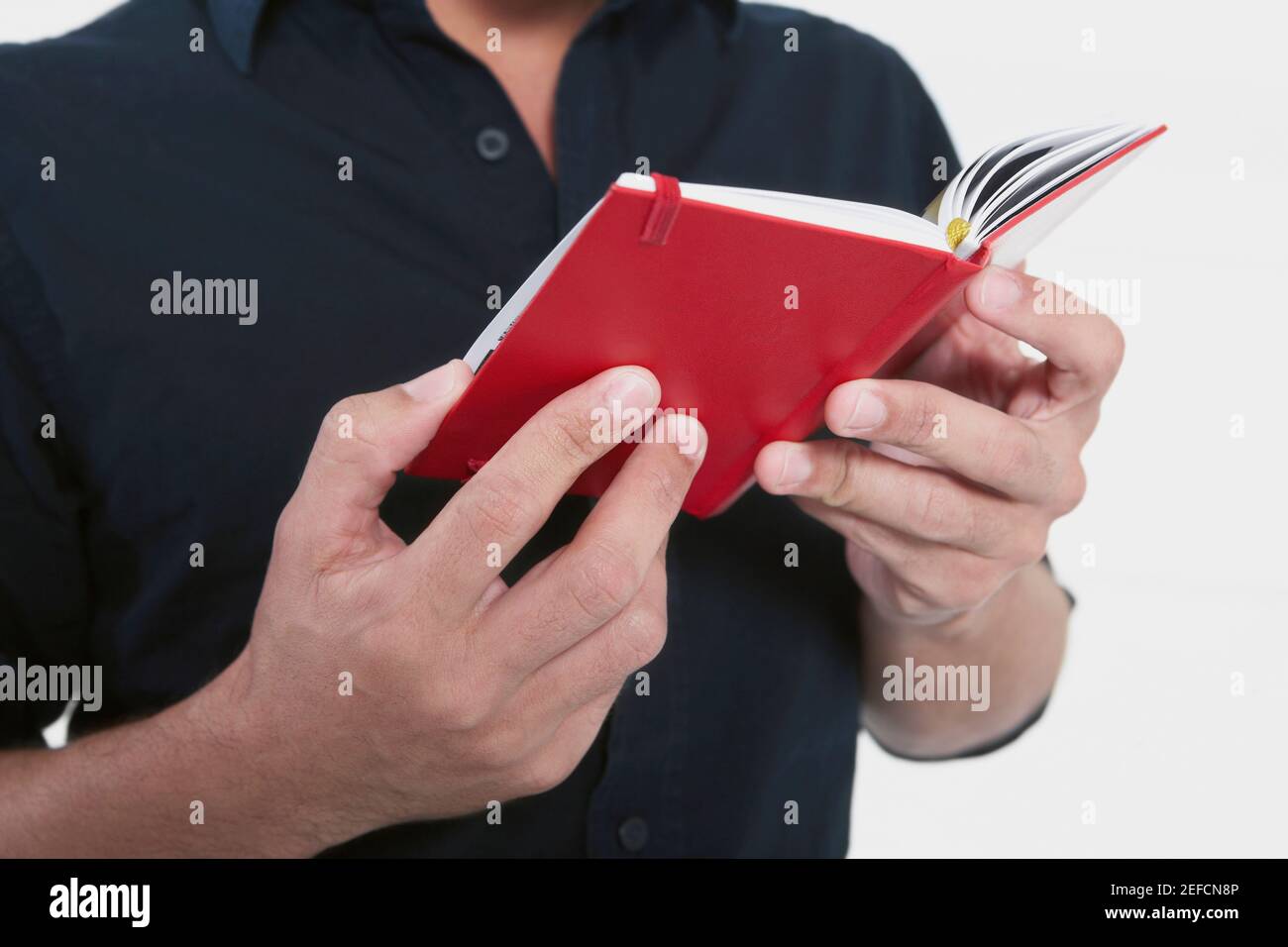 Mid section view of a man holding a diary Stock Photo - Alamy