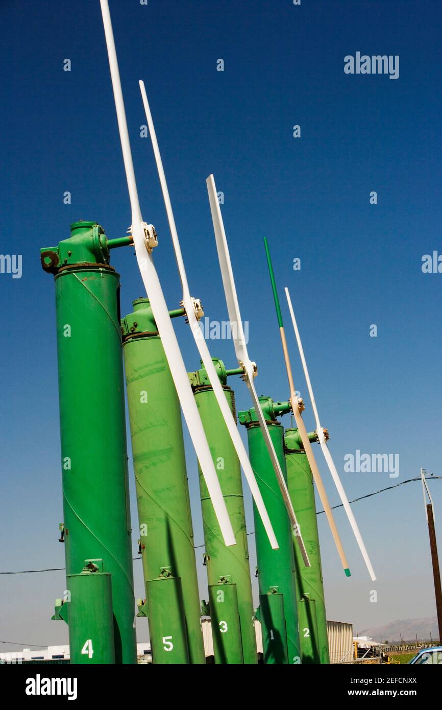 Side profile of an array of windmills on a farm Stock Photo - Alamy