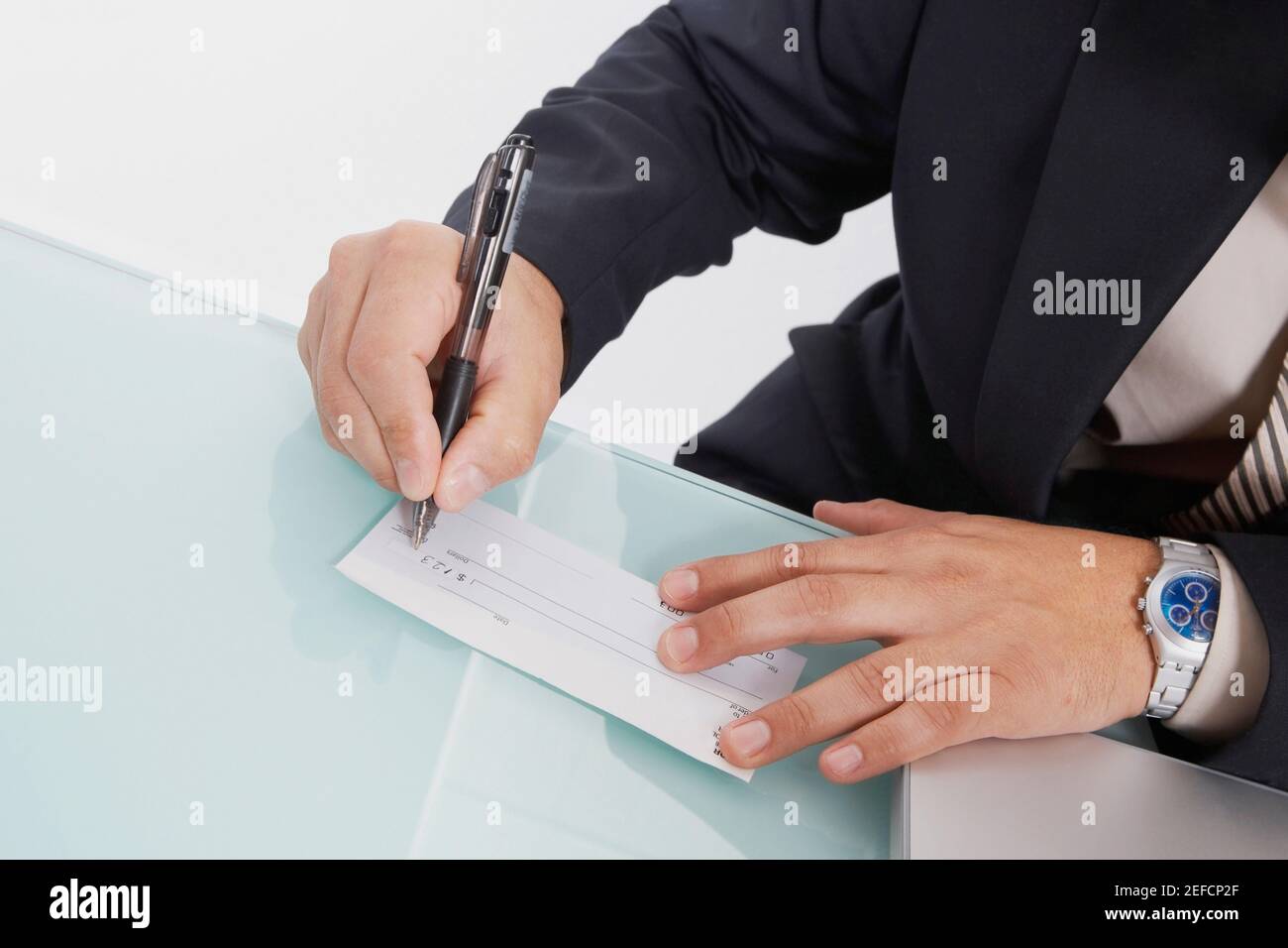 Mid section view of a man writing a check Stock Photo - Alamy