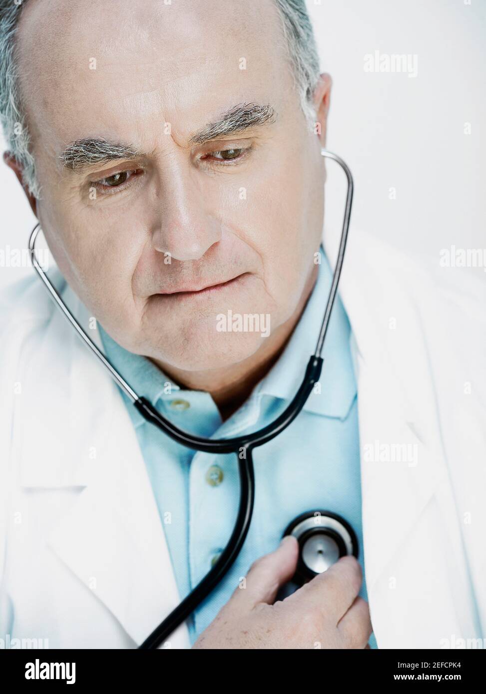 Close up of a male doctor examining himself with a stethoscope Stock ...