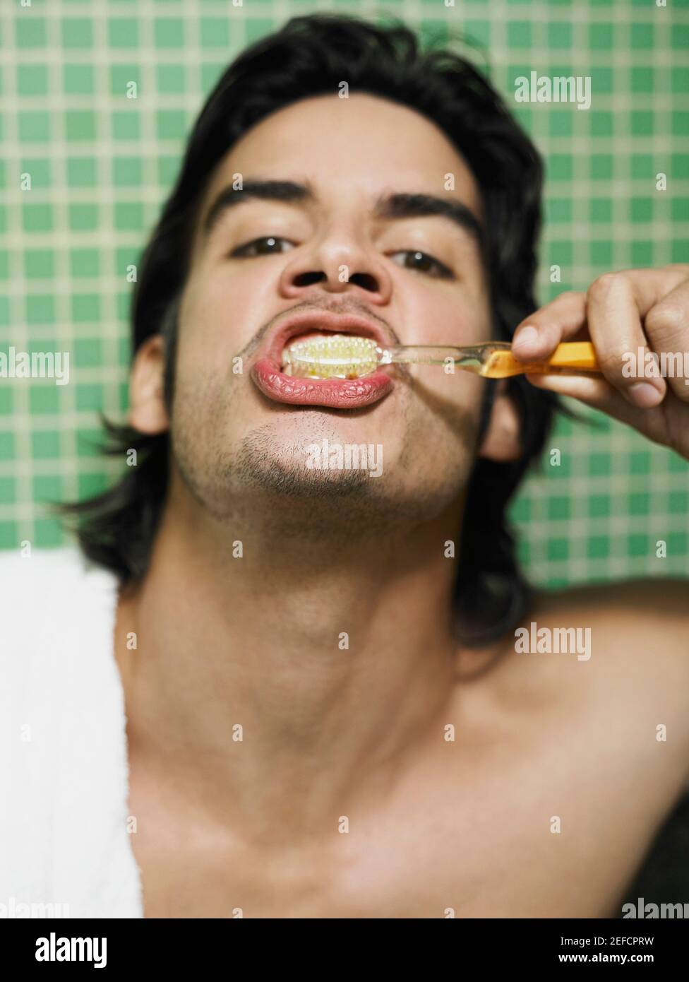 Portrait of a young man brushing his teeth Stock Photo - Alamy