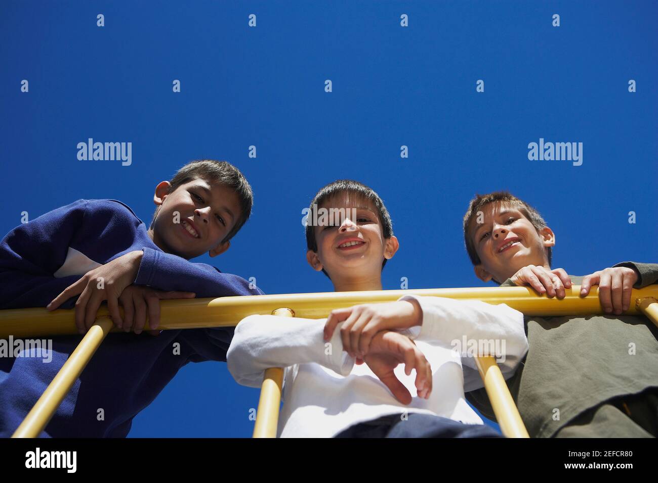 Boy leaning railing outdoors hi-res stock photography and images - Alamy
