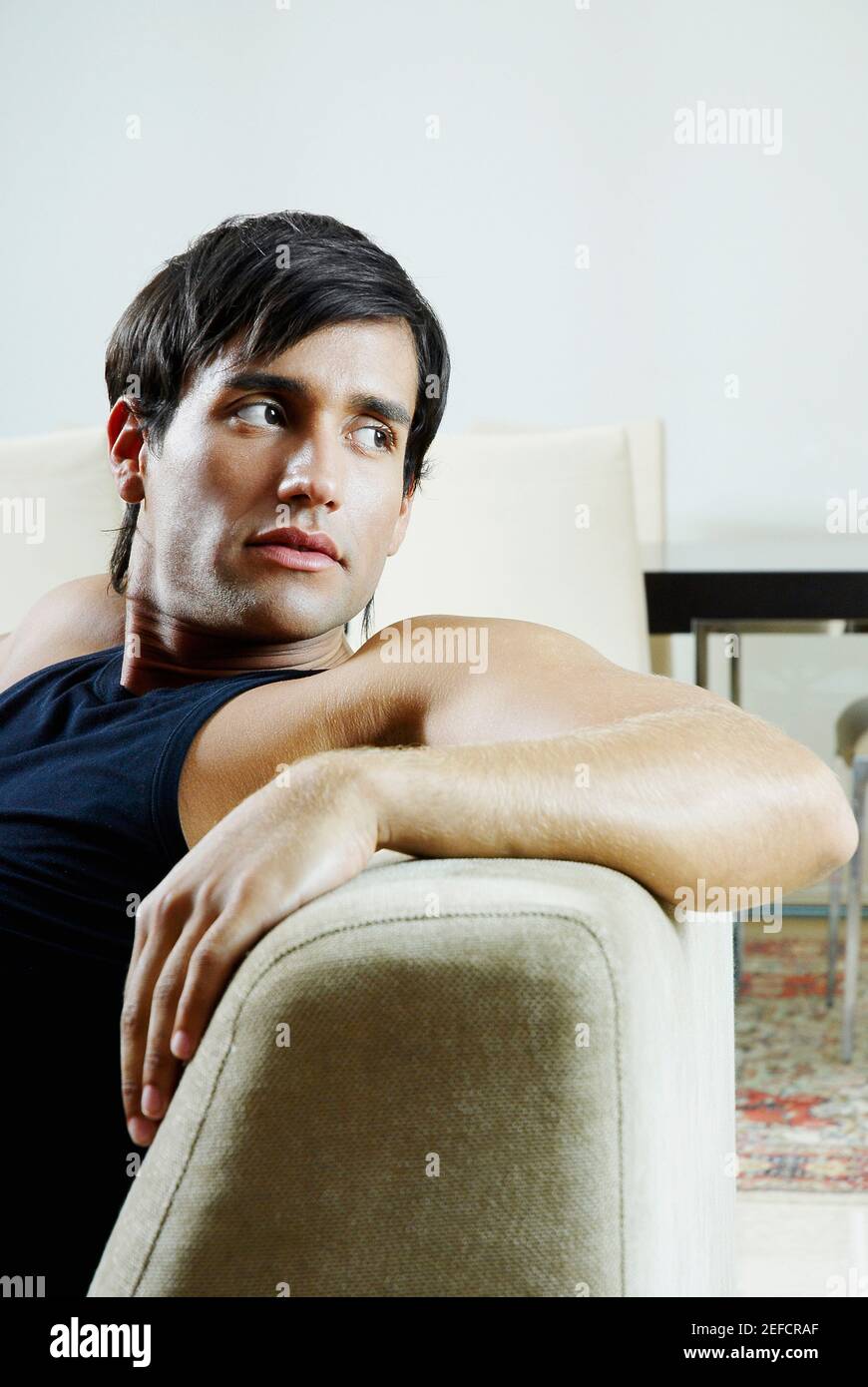 Adult man sitting sideways on hi-res stock photography and images - Alamy