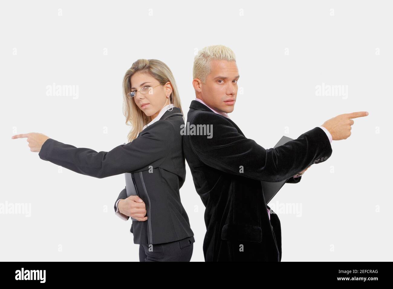 Portrait of a businesswoman and a businessman standing back to back and ...