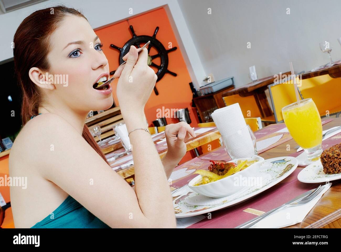 Side profile of a woman drinking with a straw hi-res stock photography ...