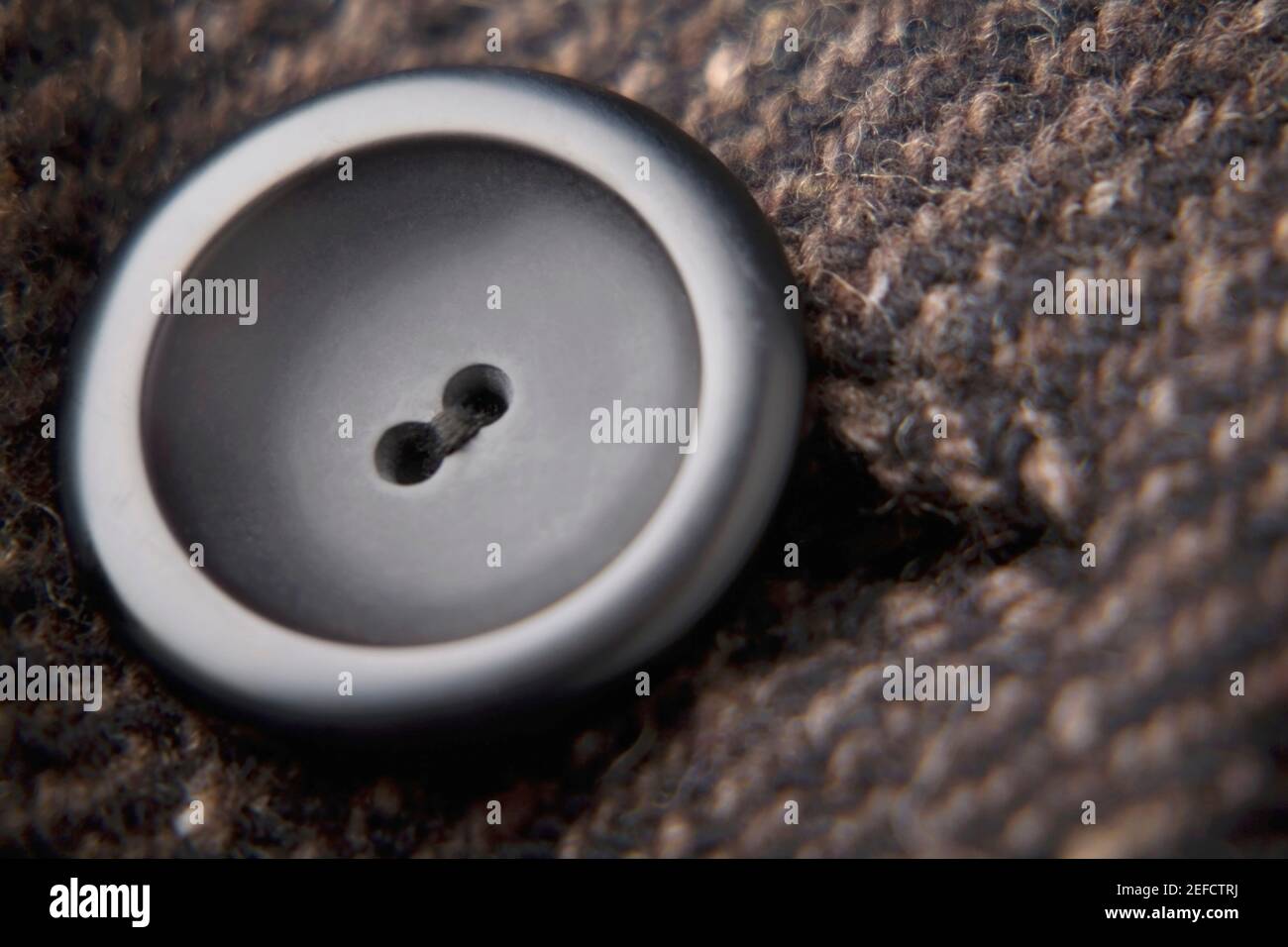 Close up of a button on a sweater Stock Photo - Alamy
