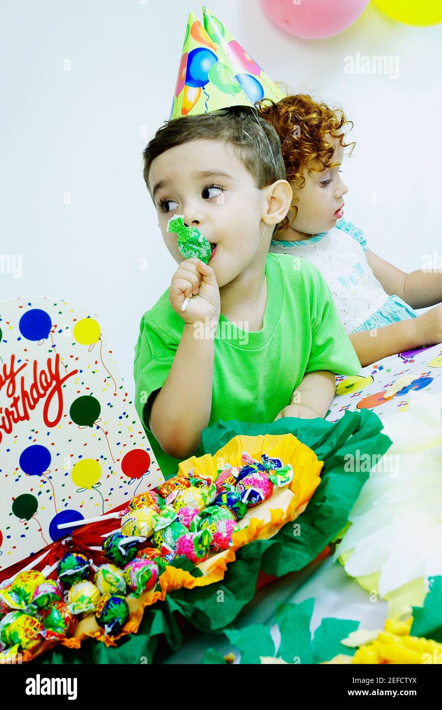 Boy eating candy at a birthday party Stock Photo - Alamy