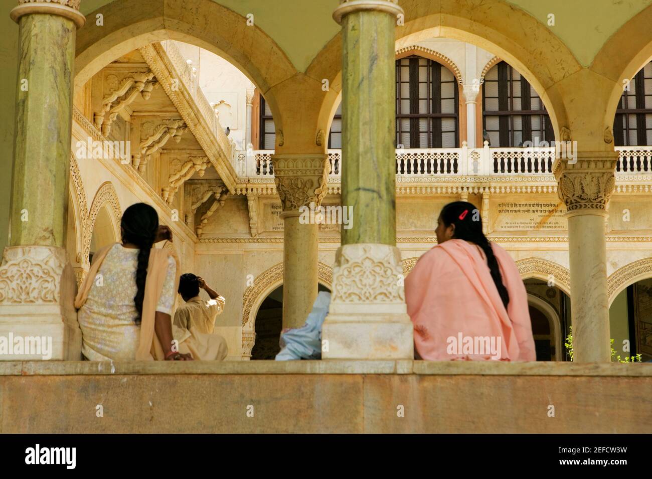 Low angle view of two women sitting inside a museum, Government Central ...