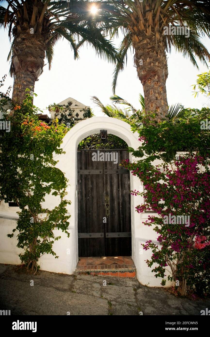 Facade of wooden doors in a stucco arch, Los Angeles, California, USA ...