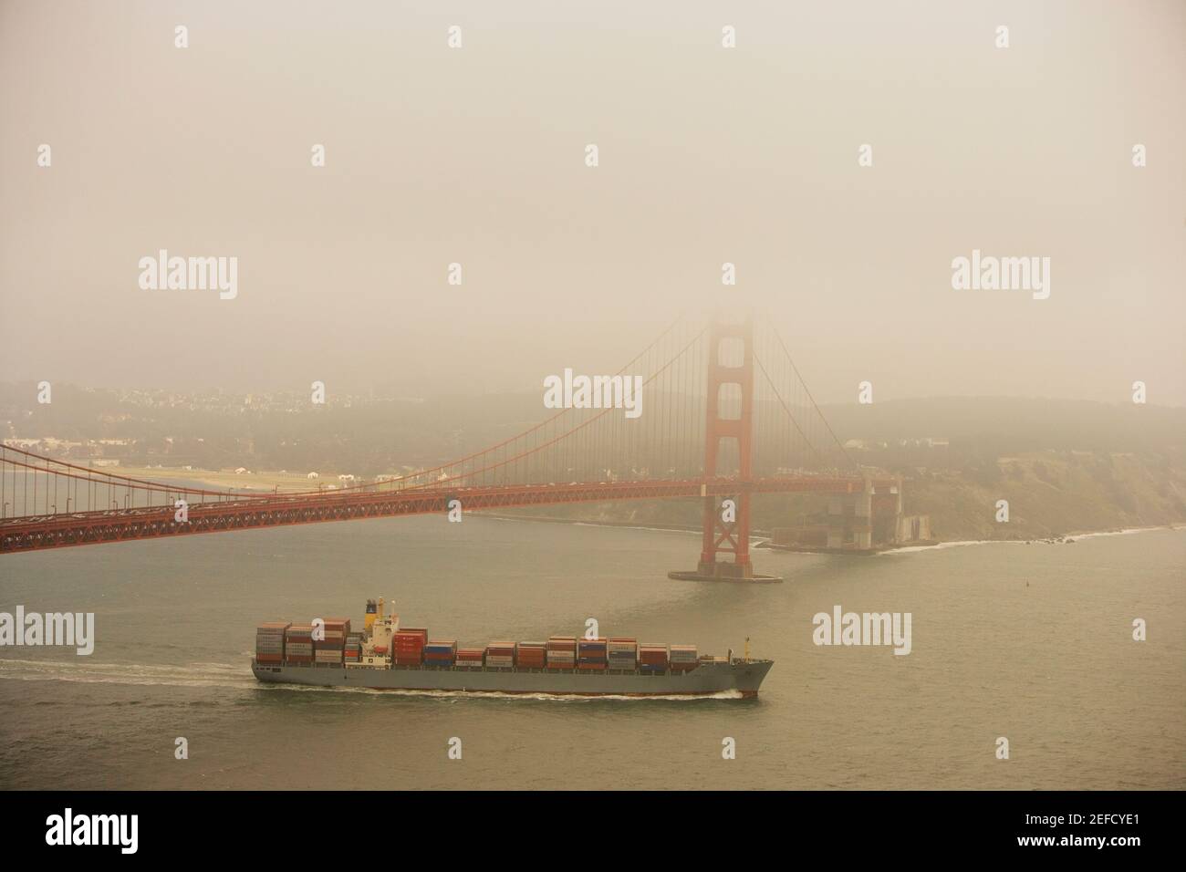 Container ship passing under a bridge, Golden Gate Bridge, San ...