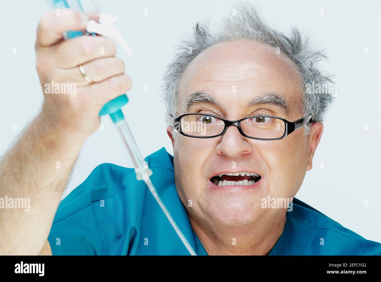 Close up of a senior man holding an iv drip and making a face Stock ...