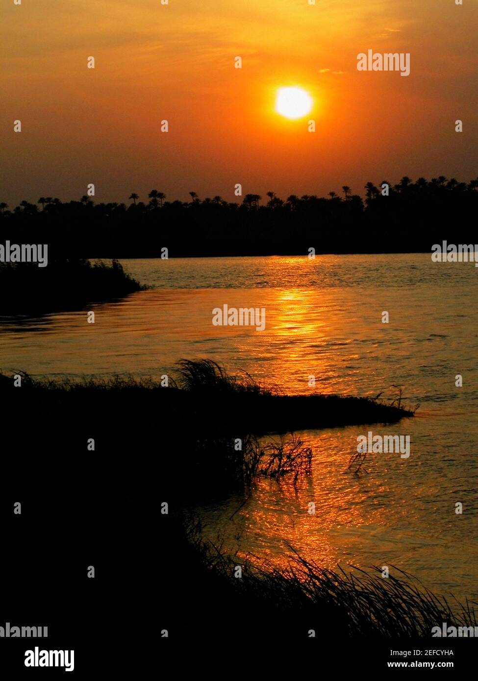 Sunset over a river Stock Photo - Alamy