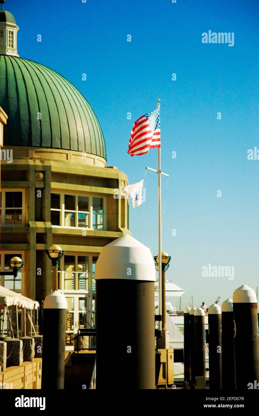 American Flag in front of a building, Rowes Wharf, Boston Harbor ...