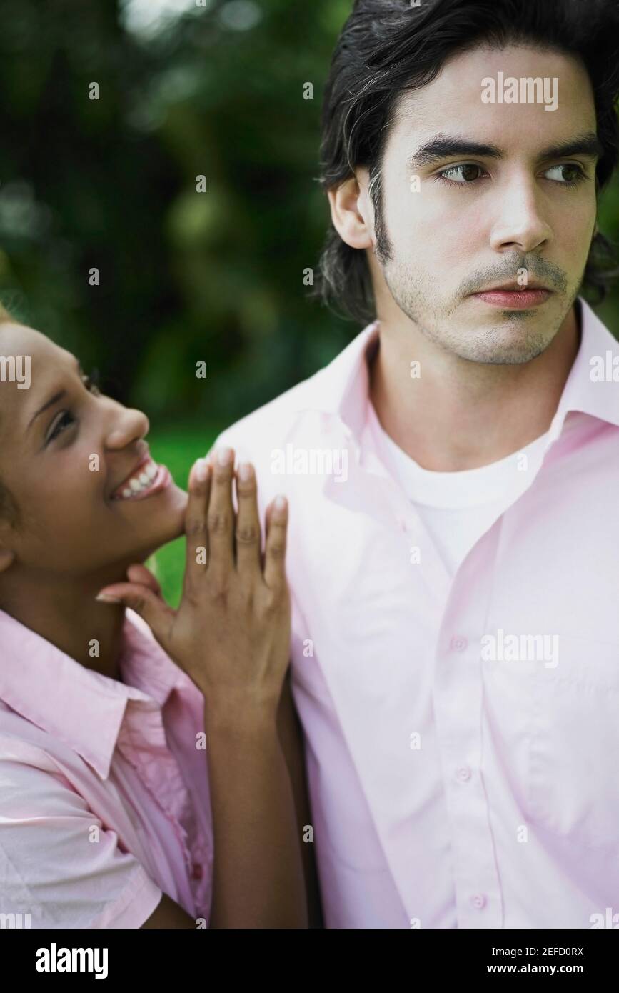 Side profile of a young woman pleading to a young man Stock Photo - Alamy