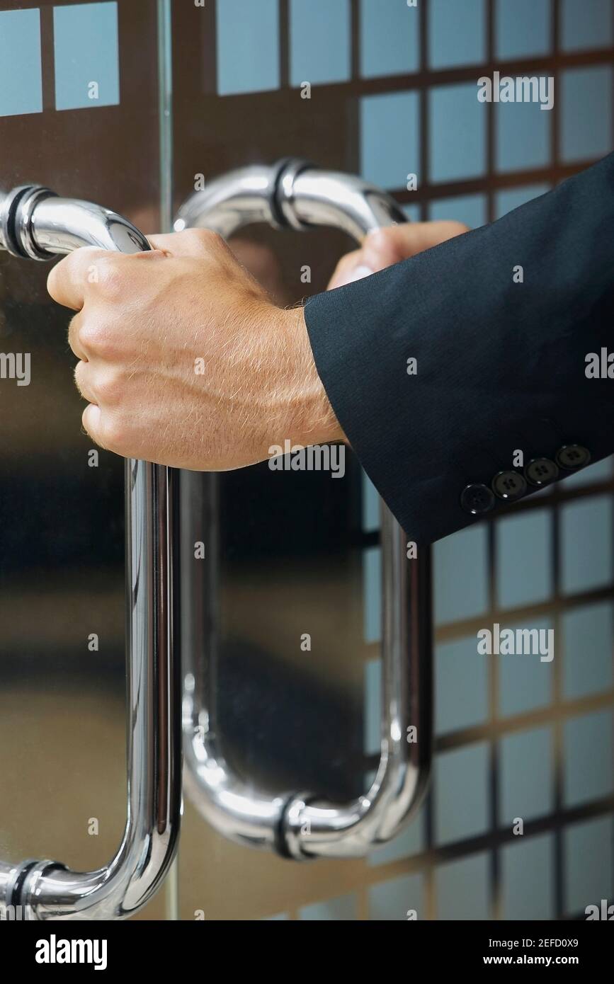 Close up of a personŽs hand holding a door handle Stock Photo - Alamy
