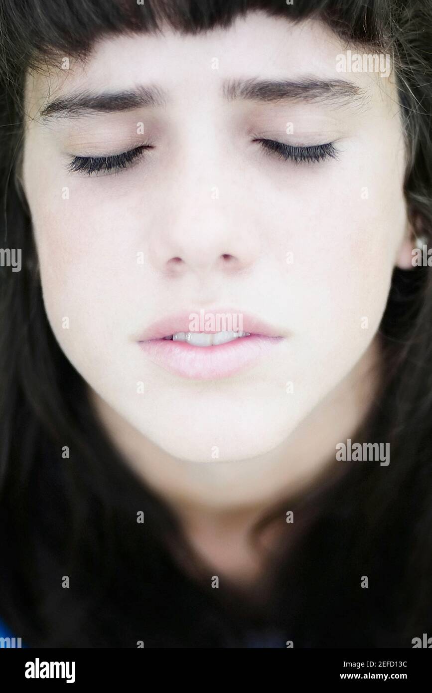 Close up of a teenage girl thinking with her eyes closed Stock Photo ...