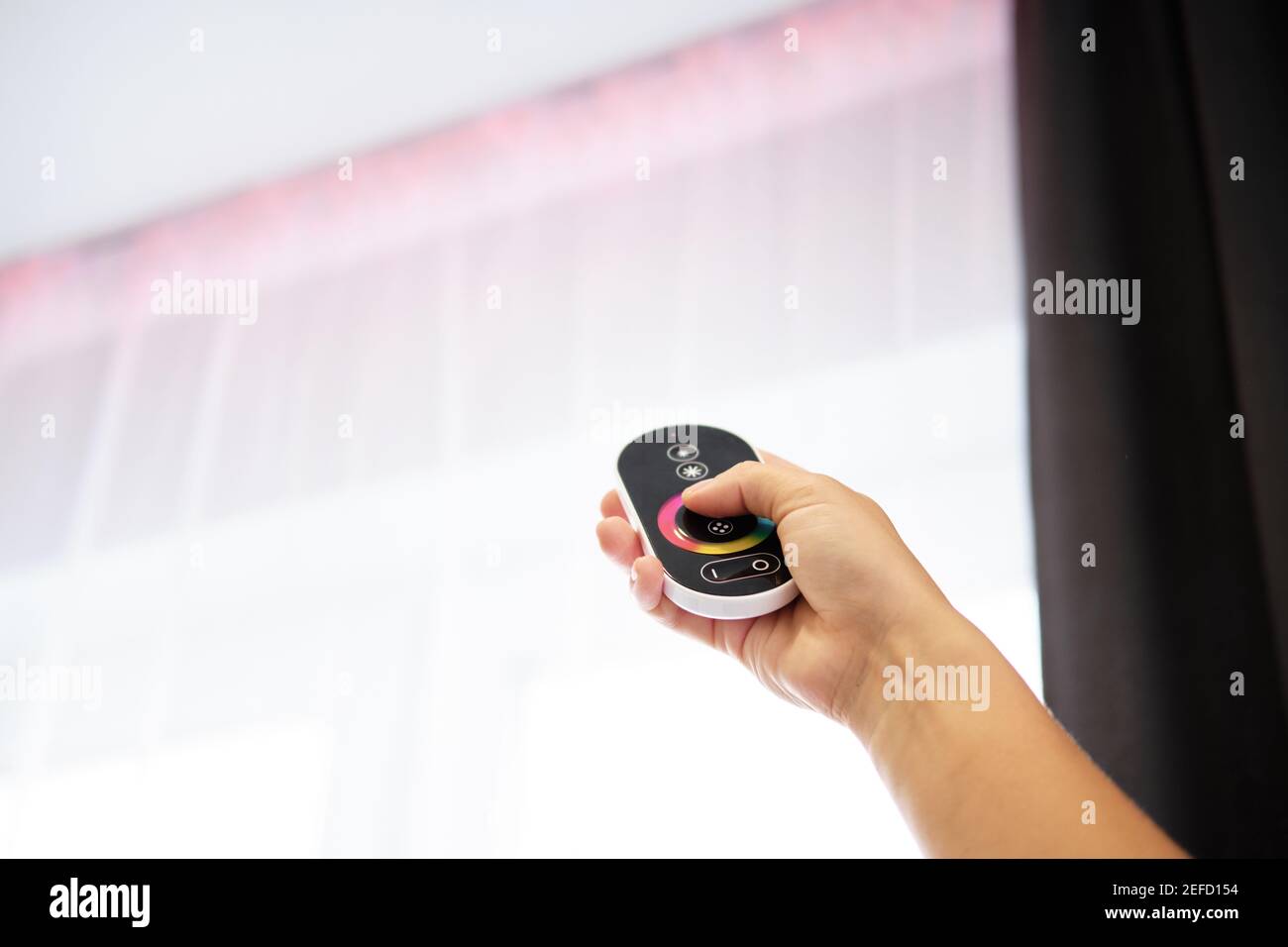 Hand with Remote control on off. LED light Remote Control. LED ...
