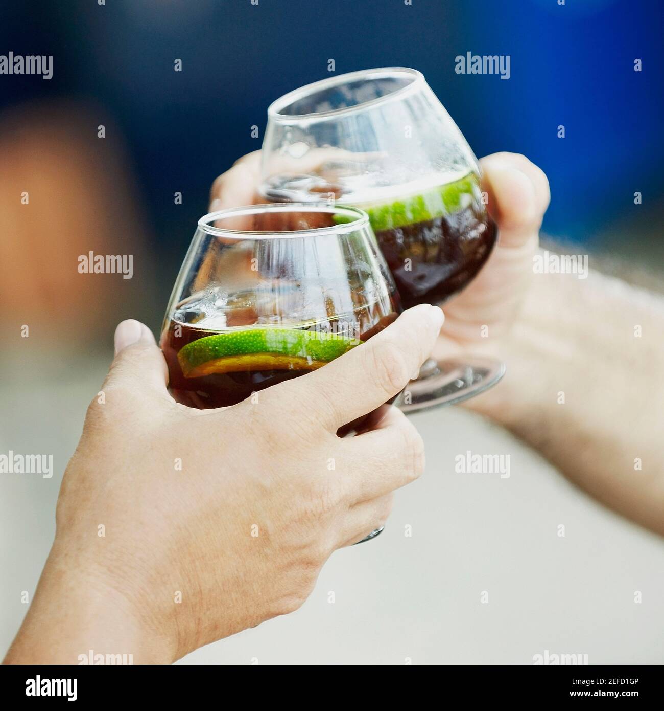 Close up of two hands toasting with wine glasses Stock Photo - Alamy