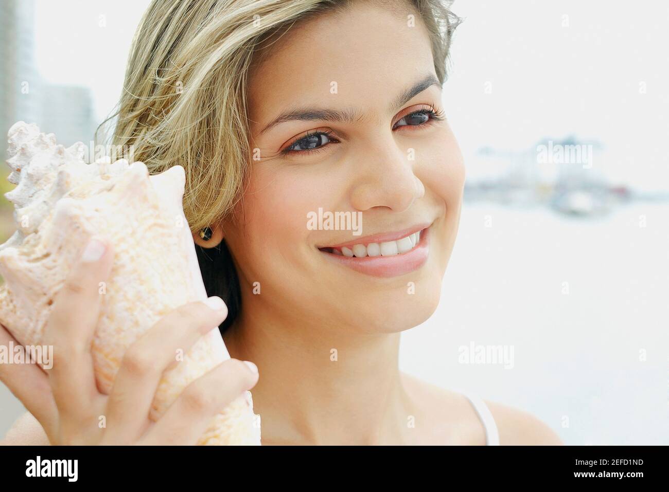 Holding conch shell hi-res stock photography and images - Alamy