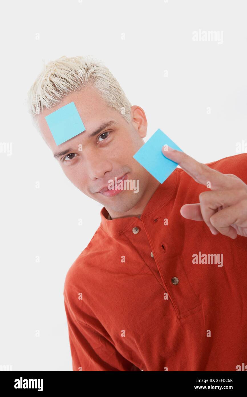 Portrait of a young man with an adhesive note on his forehead Stock ...
