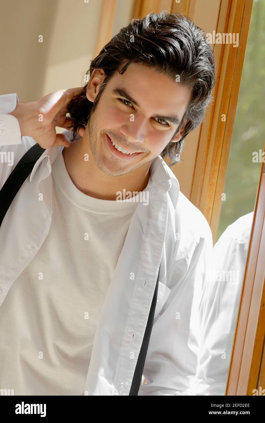 Hand in hair smiling looking down standing hi-res stock photography and ...