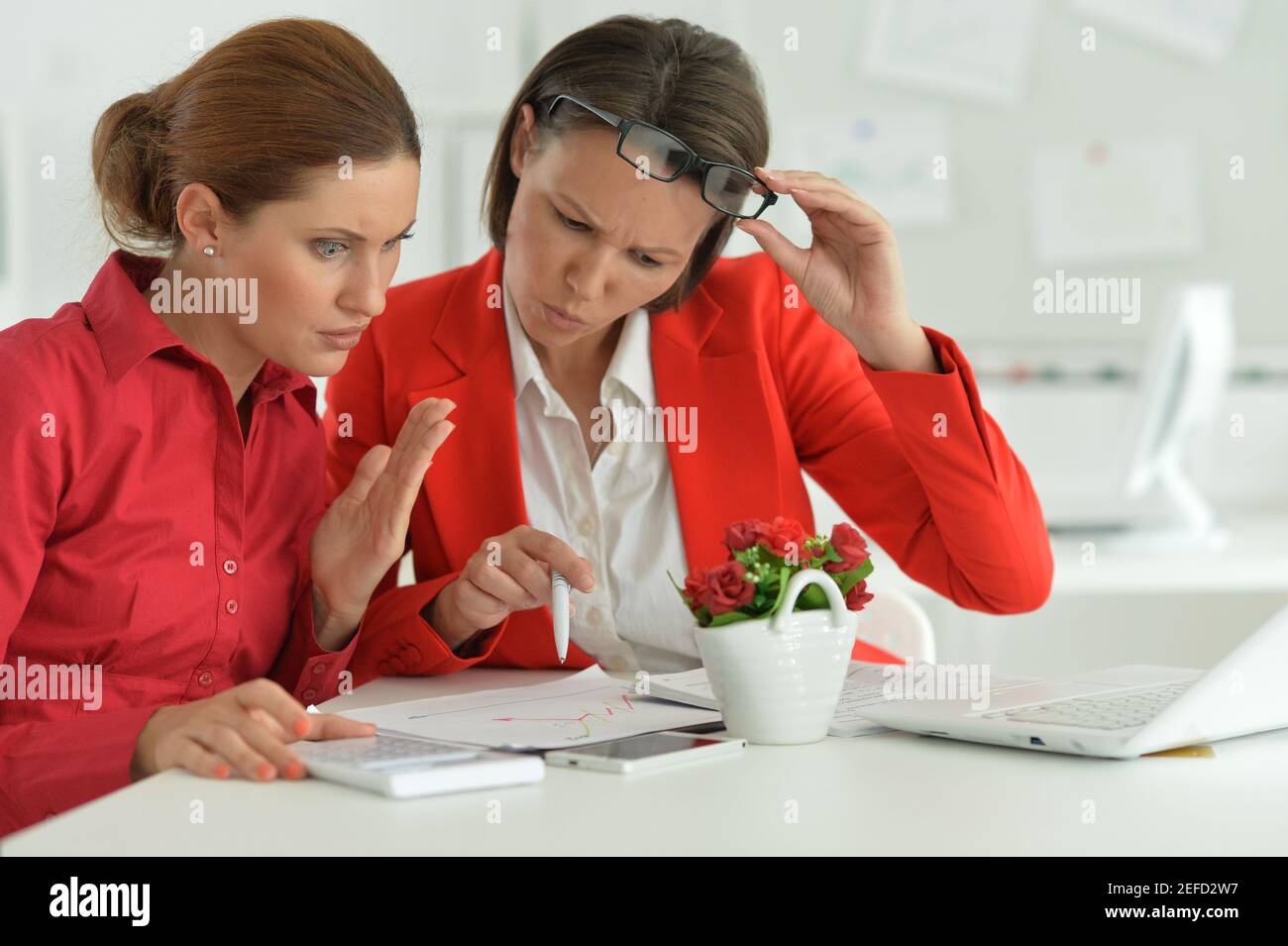 Confused women architects working in modern office Stock Photo - Alamy