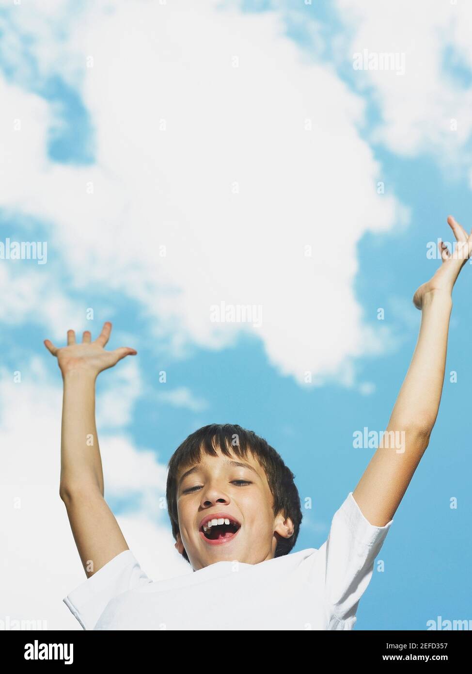 Portrait of a boy with his arms raised Stock Photo - Alamy