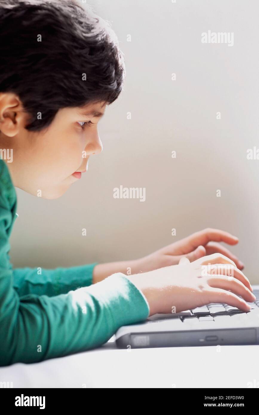 Close up of a boy using a laptop Stock Photo - Alamy
