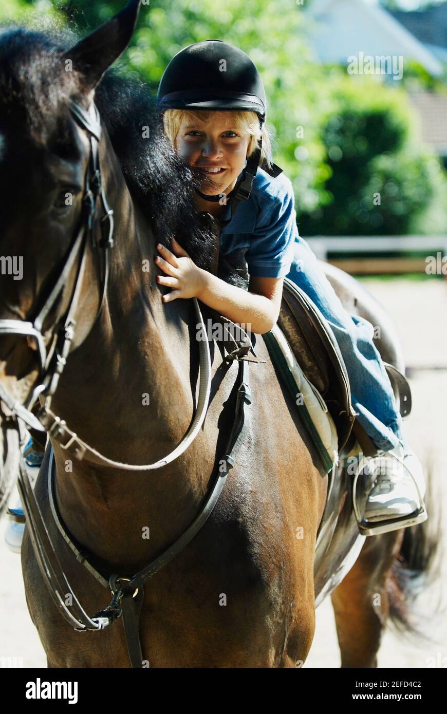 Portrait of a boy horseback riding Stock Photo - Alamy