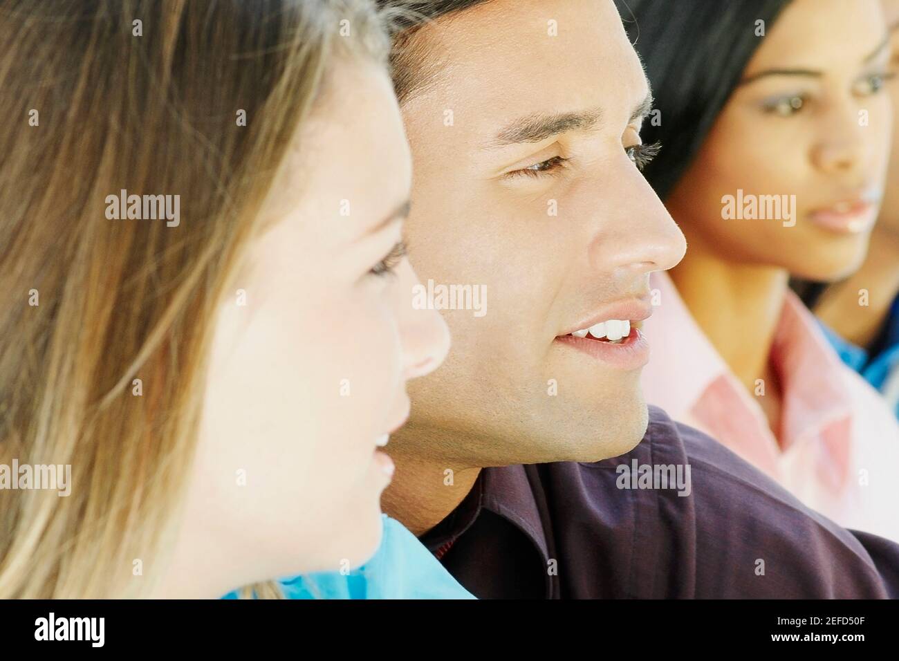 Teenage girl with two young men and a young woman Stock Photo - Alamy