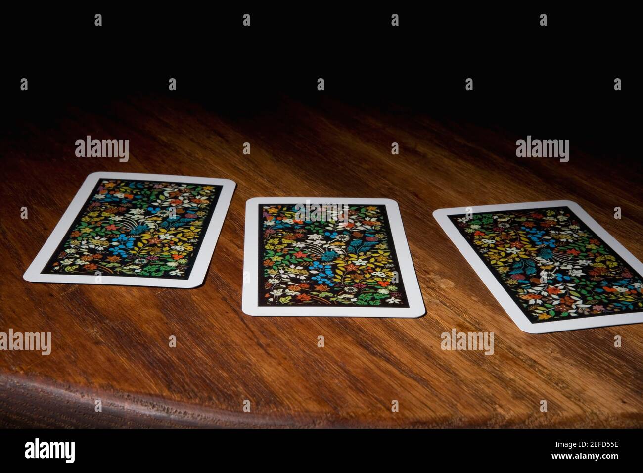 Close up of three cards on a table Stock Photo - Alamy