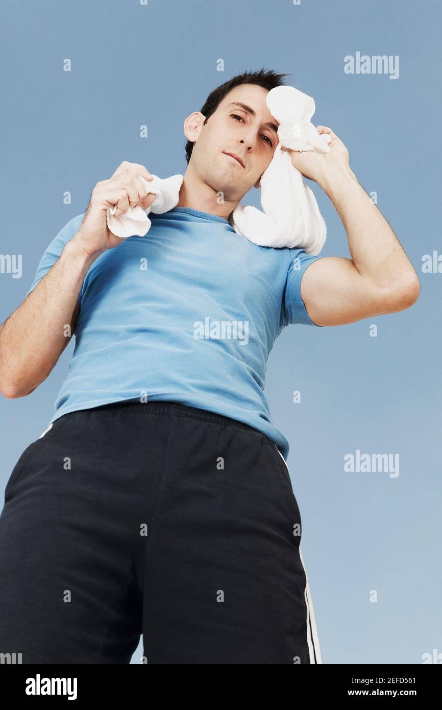 Portrait of a mid adult man wiping his face with a towel Stock Photo ...