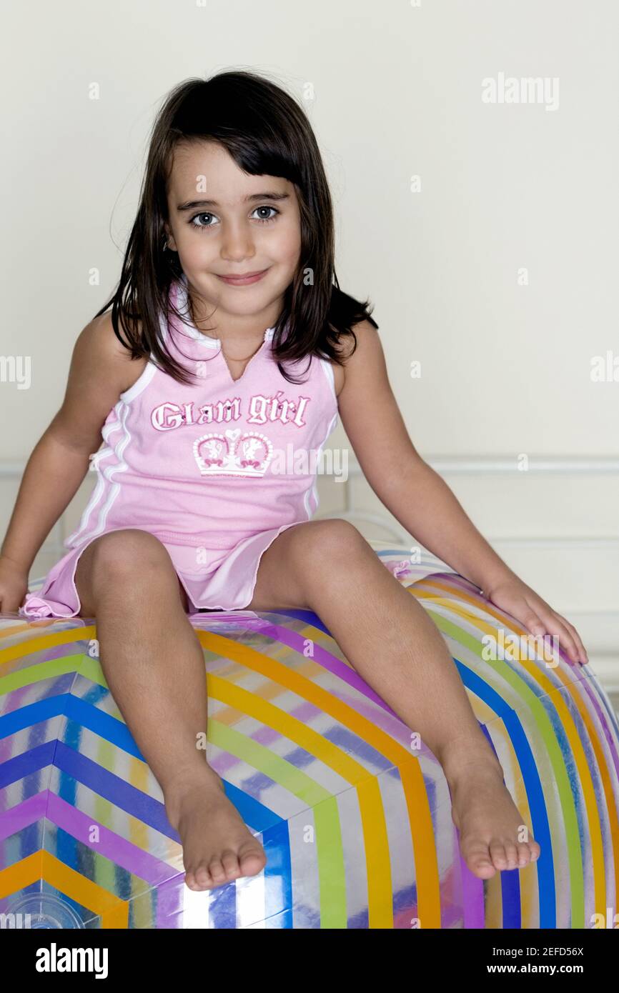 Portrait of a girl sitting on a large inflatable ball Stock Photo - Alamy