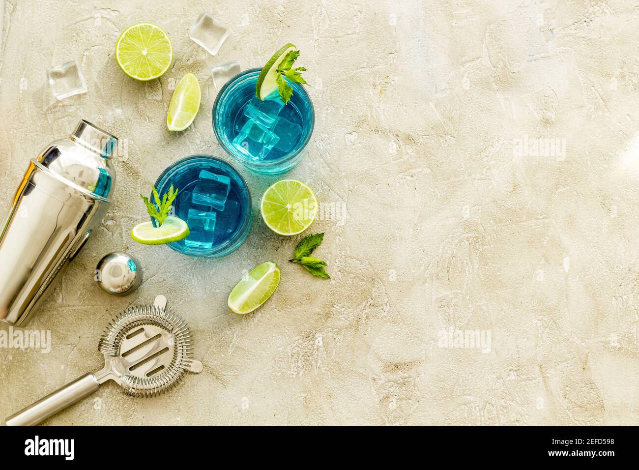 Blue cocktail drinks with bar tools and ice, top view Stock Photo - Alamy