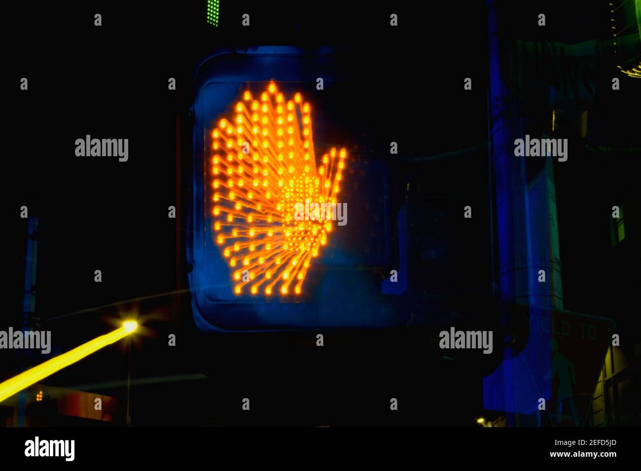 Stop sign lit up at night Stock Photo - Alamy