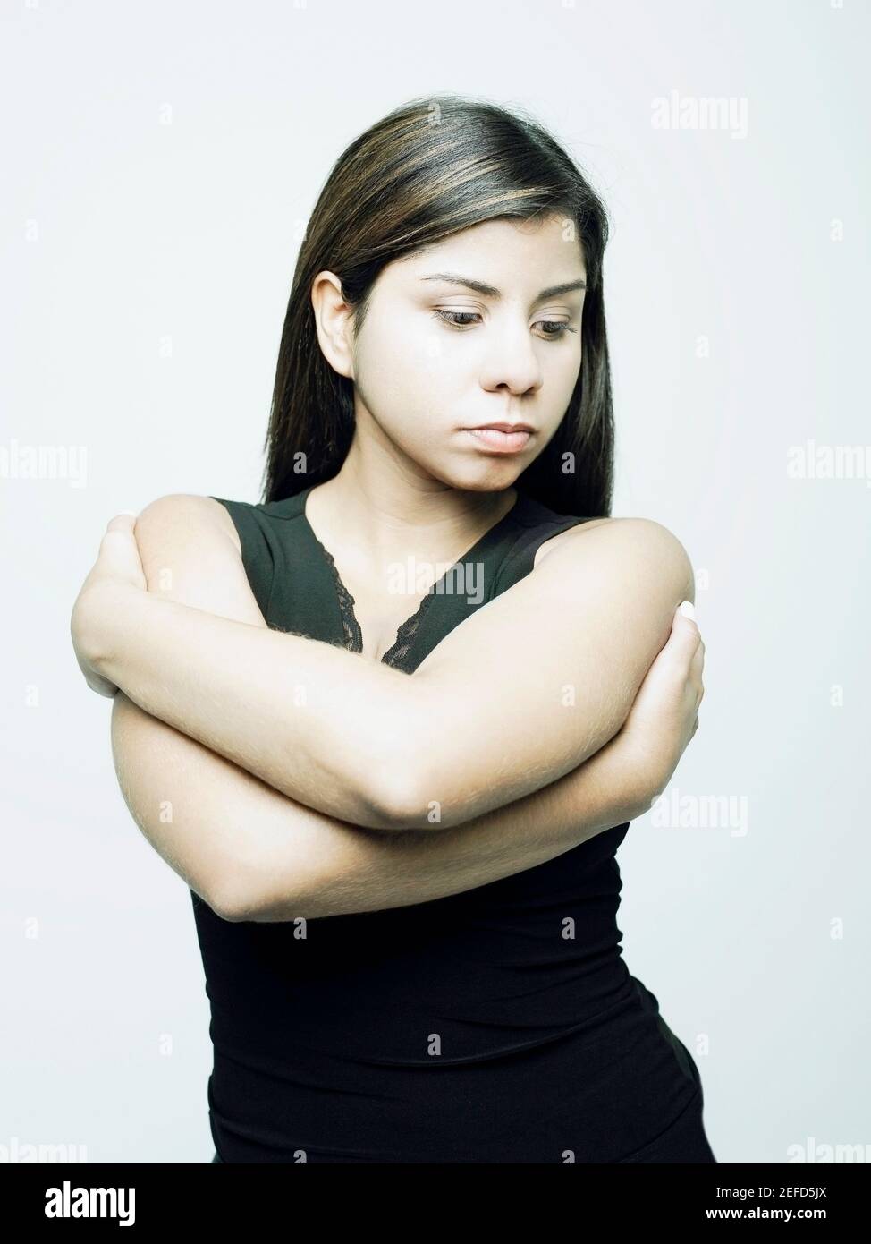 Young woman hugging herself hi-res stock photography and images - Alamy