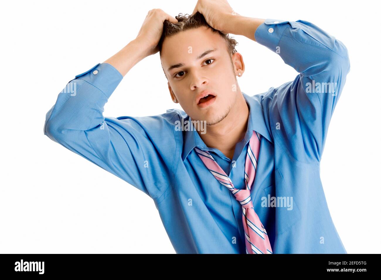 Portrait of a young man pulling his hair Stock Photo - Alamy