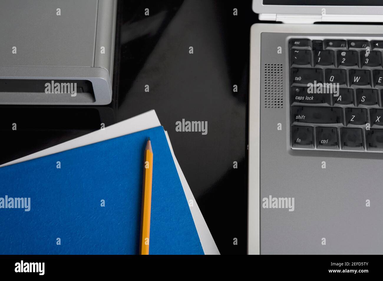 Close up of a laptop with pencil on a notebook Stock Photo - Alamy