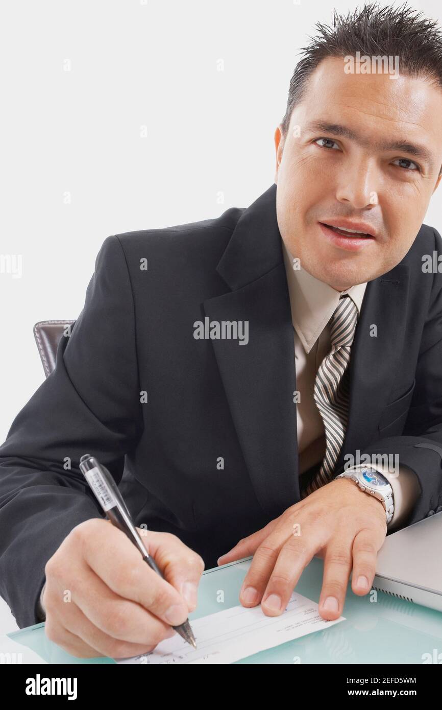 Portrait of a businessman writing a check Stock Photo - Alamy