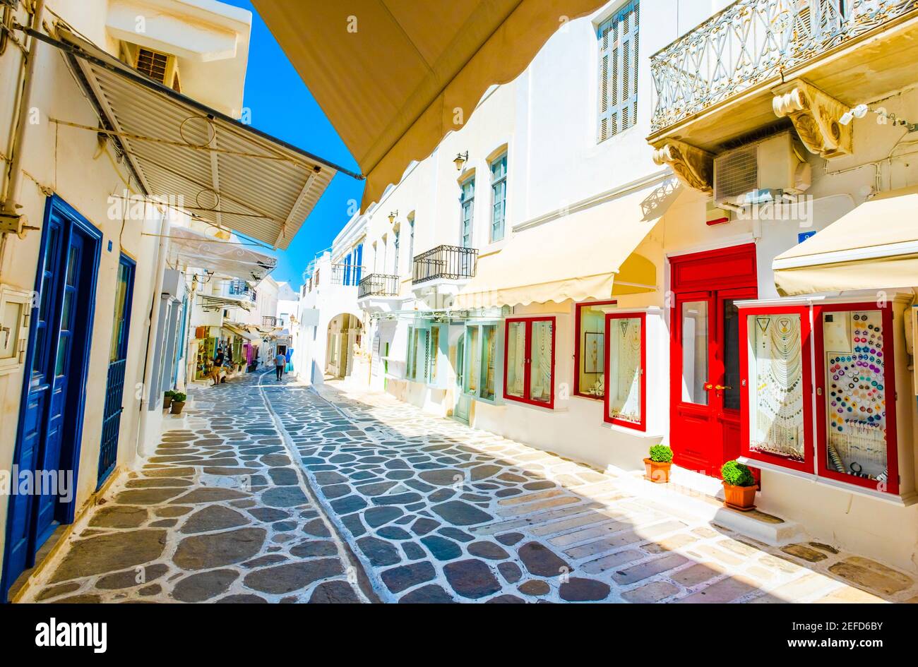 Amazing view along sunshine greek street with colorful bright door and ...