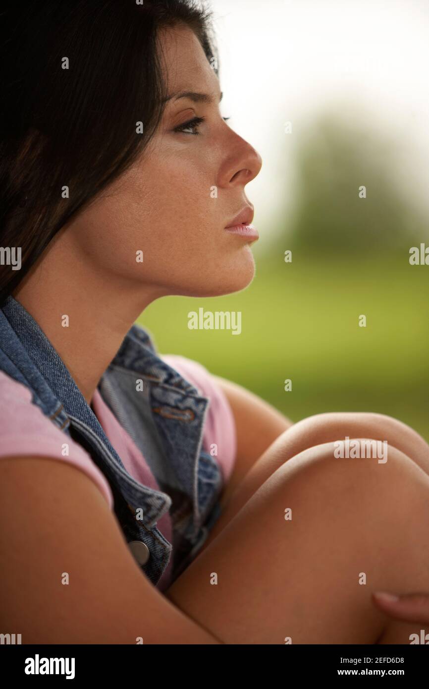 Side profile of a young woman thinking Stock Photo - Alamy