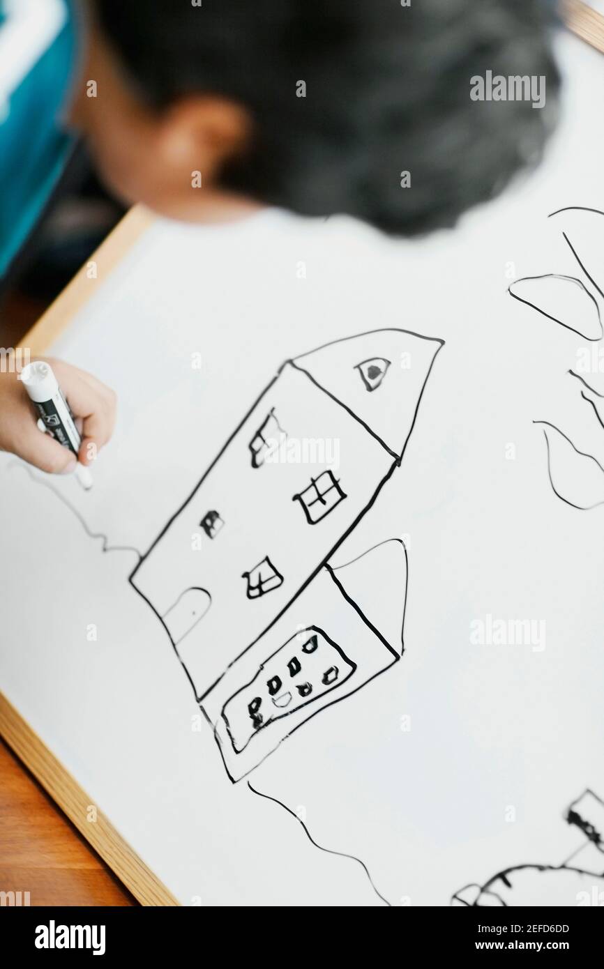 High angle view of a boy drawing sketch Stock Photo - Alamy