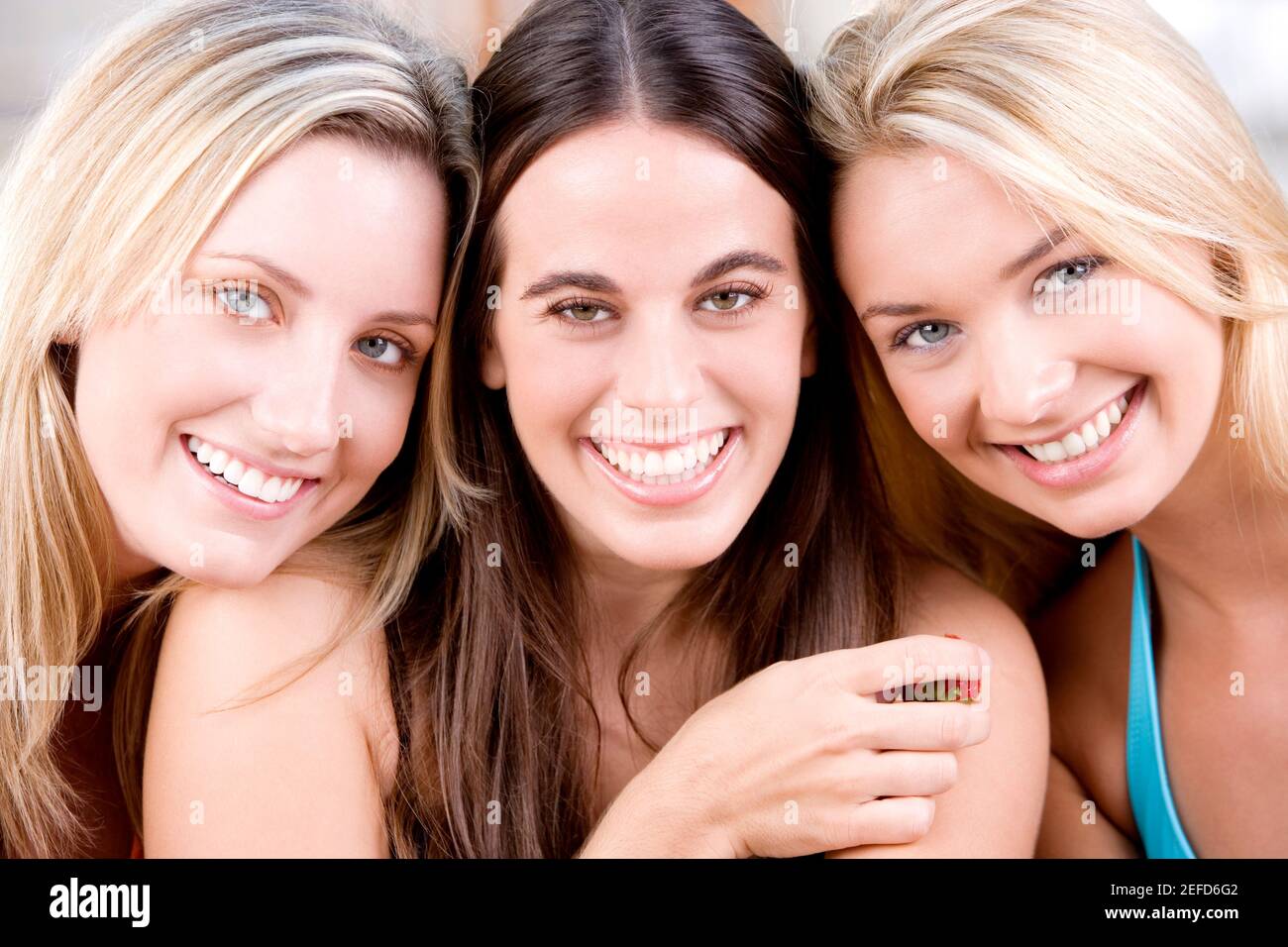 Portrait of three young women smiling Stock Photo - Alamy