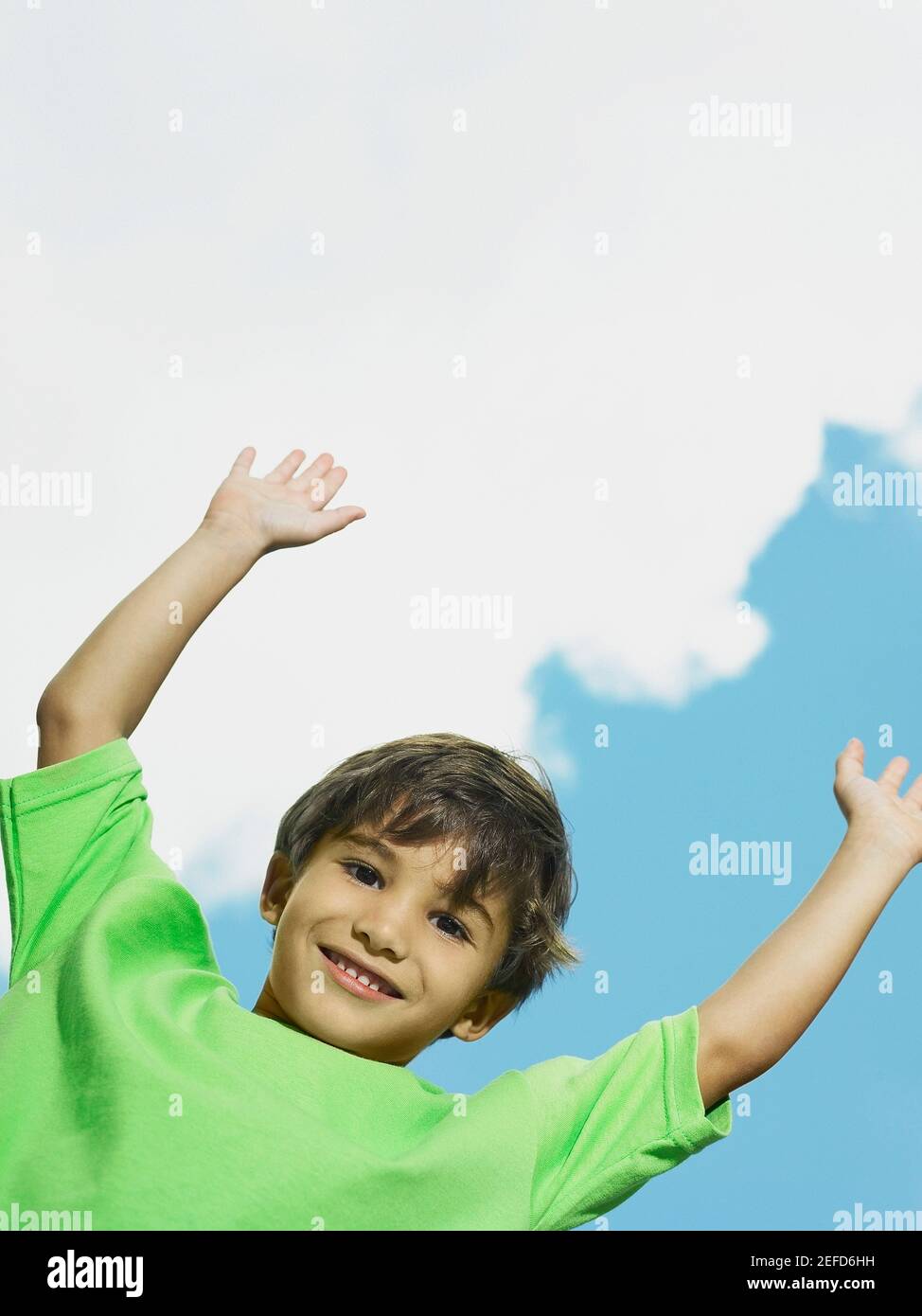 Portrait of a boy smiling with his arms raised Stock Photo - Alamy