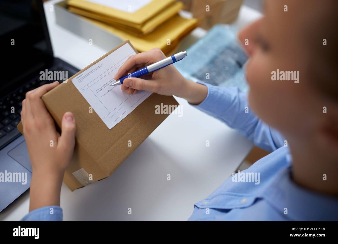 close up of woman filling postal form at office Stock Photo - Alamy