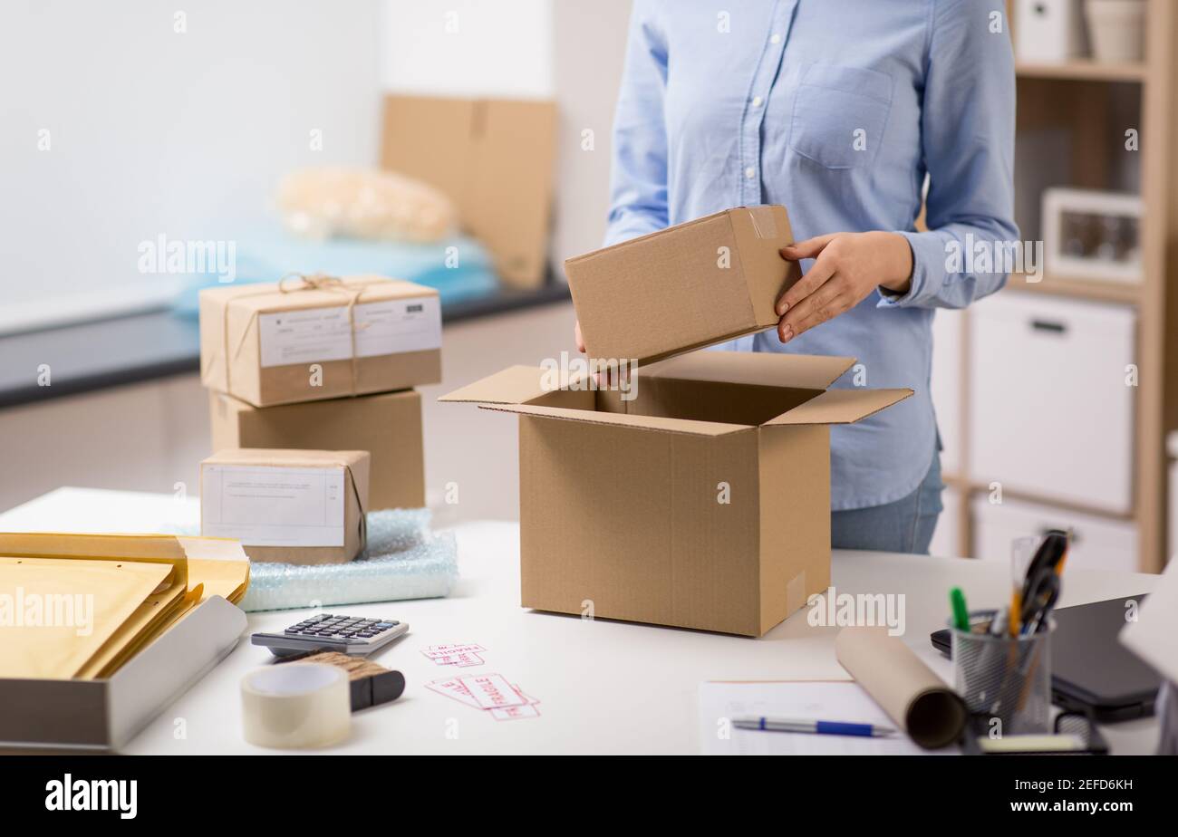 woman packing parcel box at post office Stock Photo - Alamy