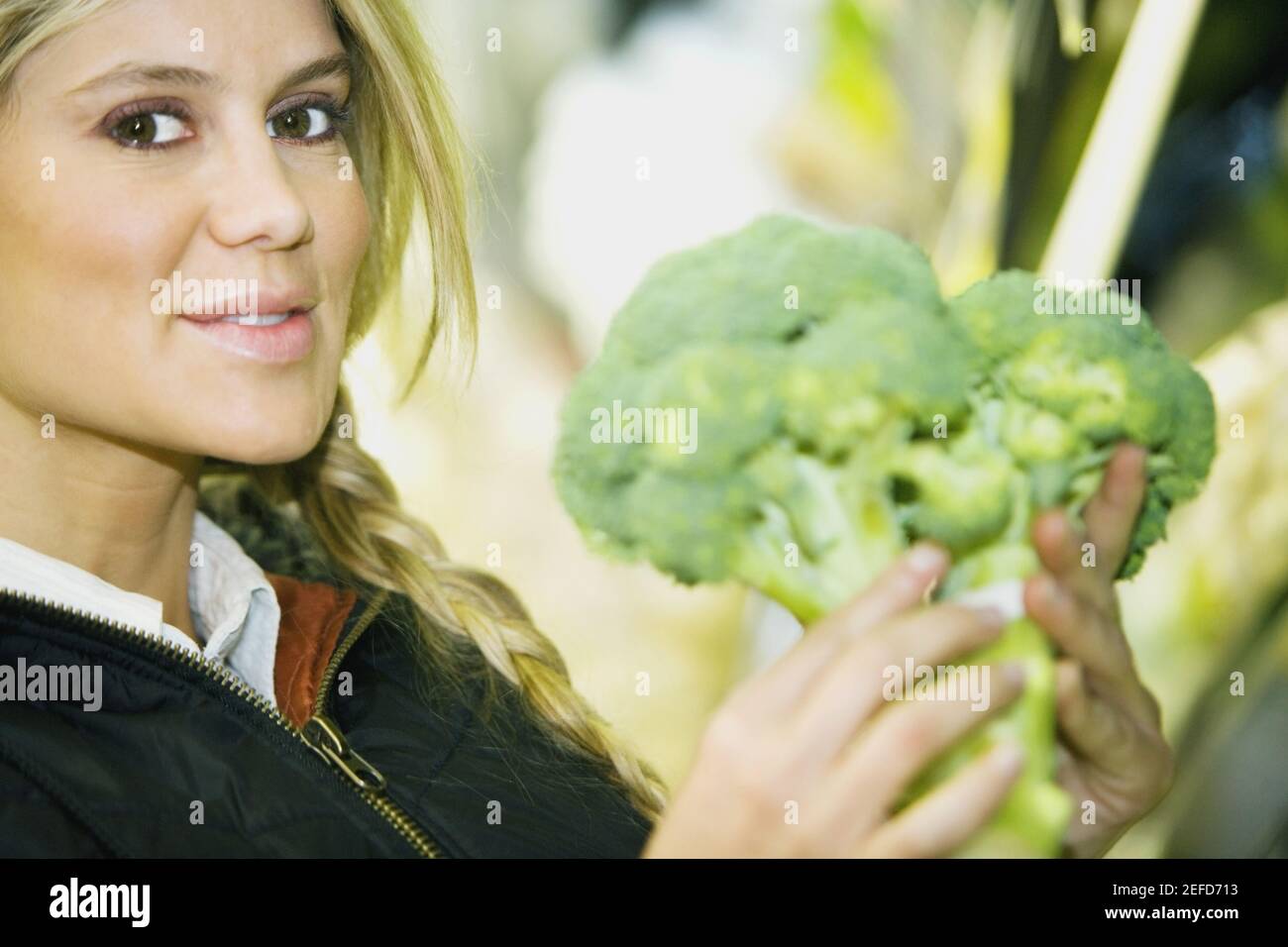 Woman broccoli looking at camera hi-res stock photography and images ...