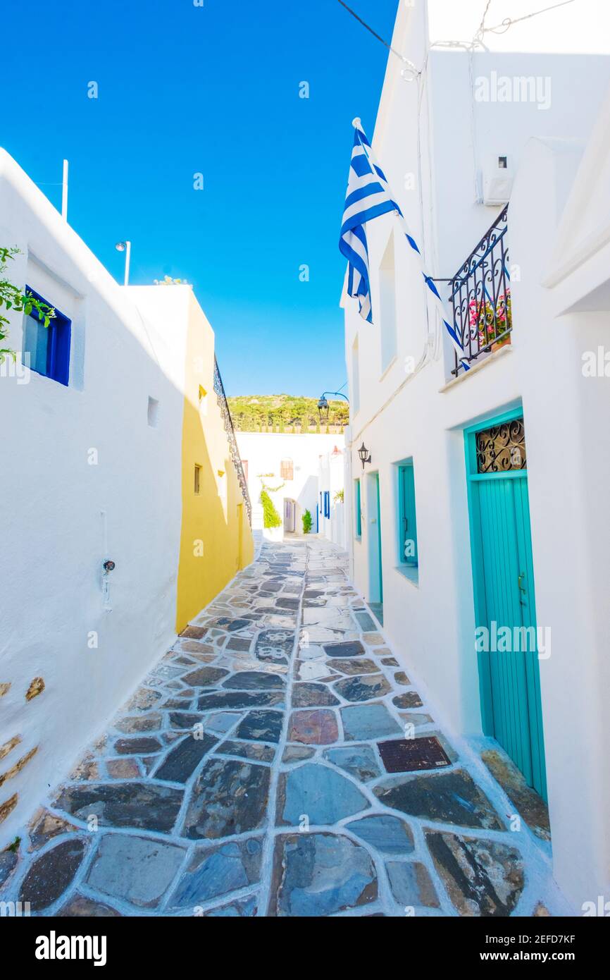 Narrow street with flagstone pavement and traditional rustic houses on ...