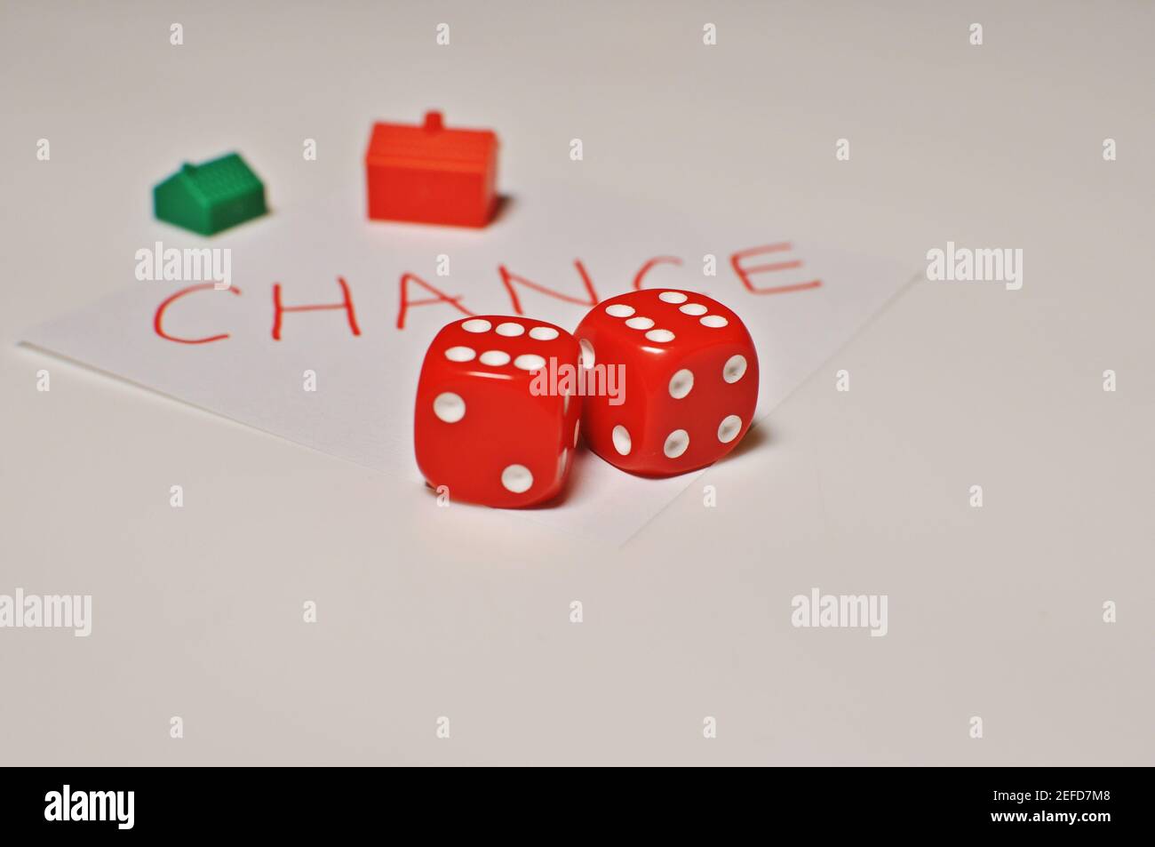 Concept of 2 red dice end the word chance written by hand on white ...