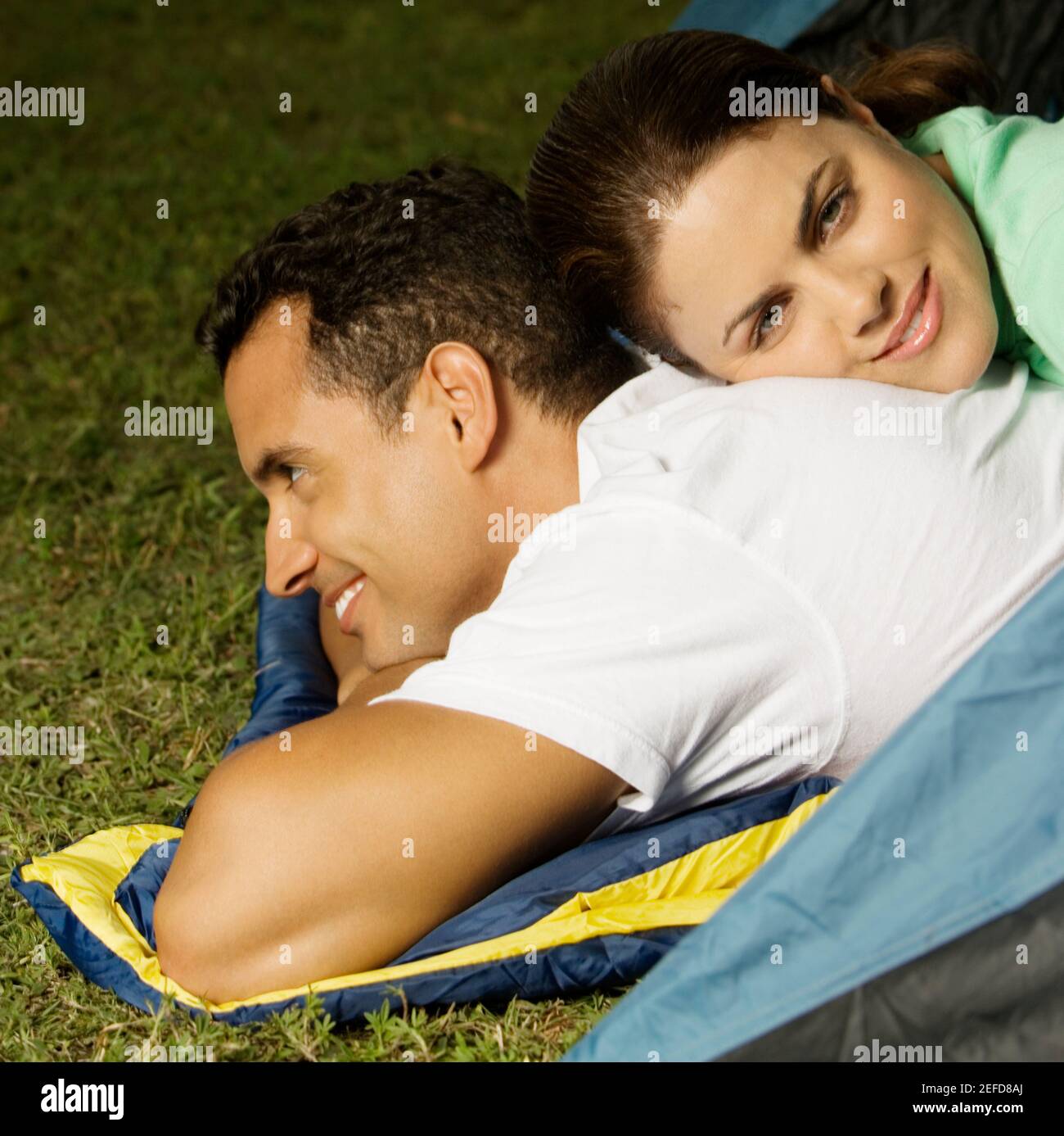 Portrait of a young woman lying on the back of a young man Stock Photo ...